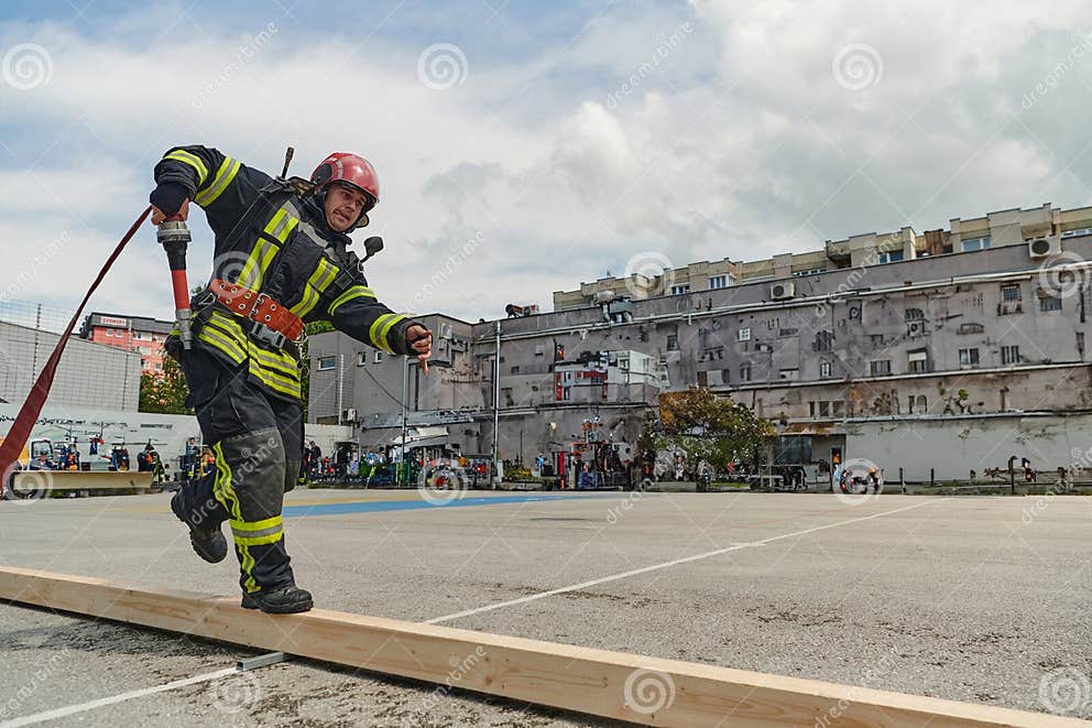 In a Dynamic Display of Synchronized Teamwork, Firefighters Hustle To ...