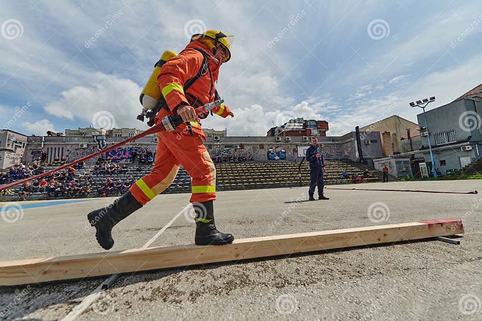 In a Dynamic Display of Synchronized Teamwork, Firefighters Hustle To ...