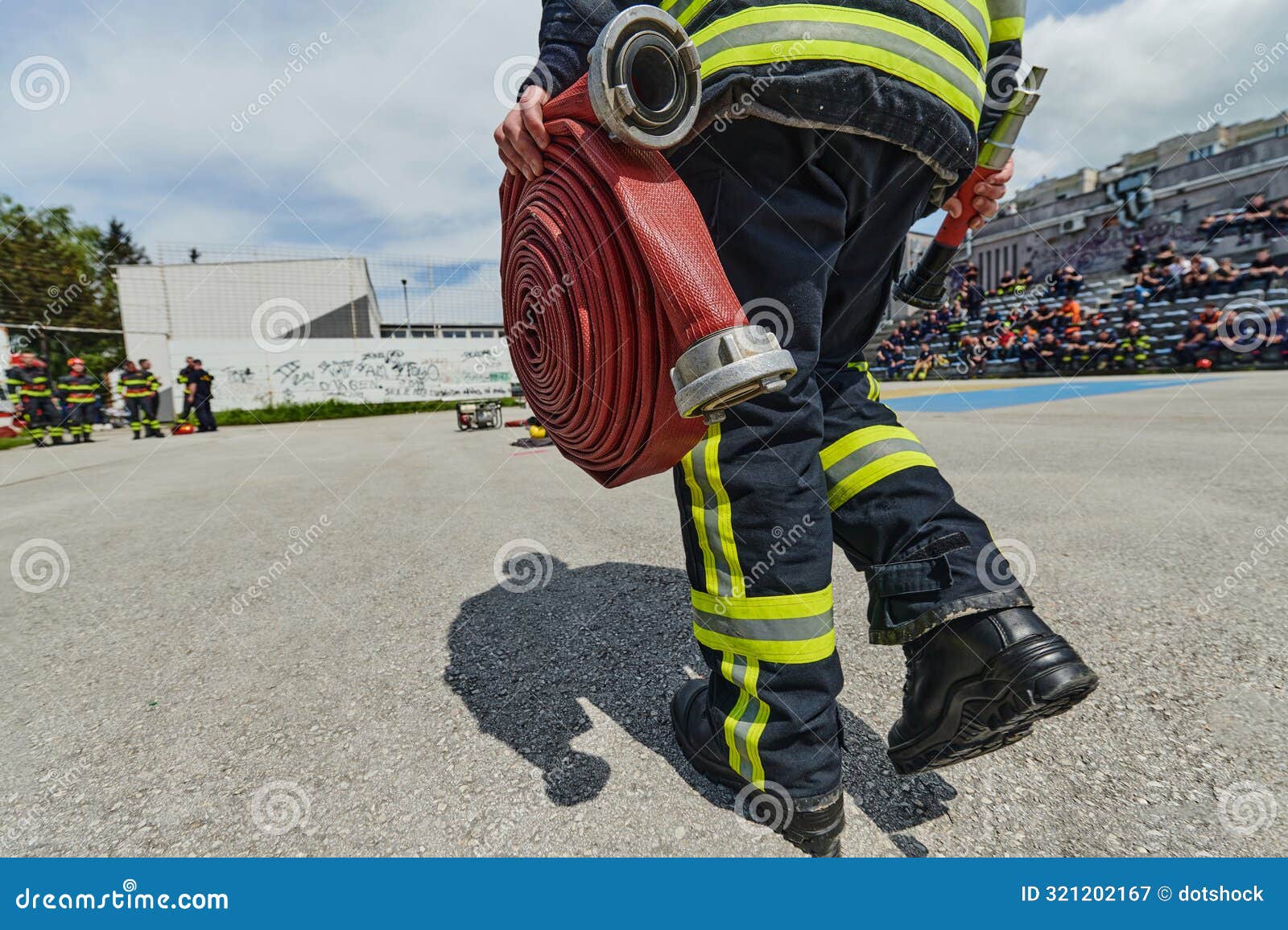 In a Dynamic Display of Synchronized Teamwork, Firefighters Hustle To ...