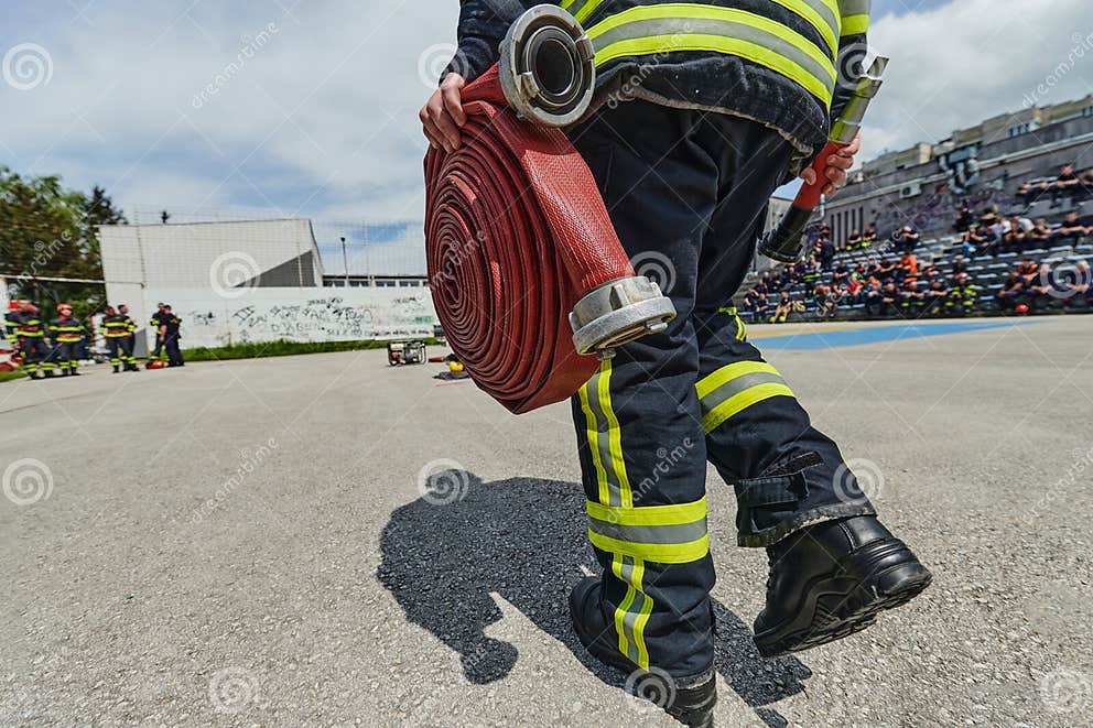 In a Dynamic Display of Synchronized Teamwork, Firefighters Hustle To ...