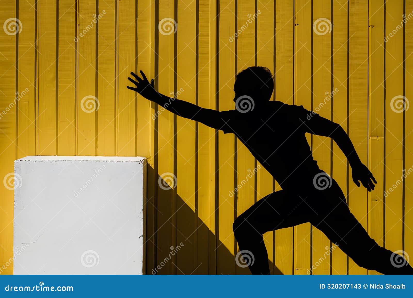 Dynamic Figure Reaching for Rectangular Block Against Vivid Yellow ...