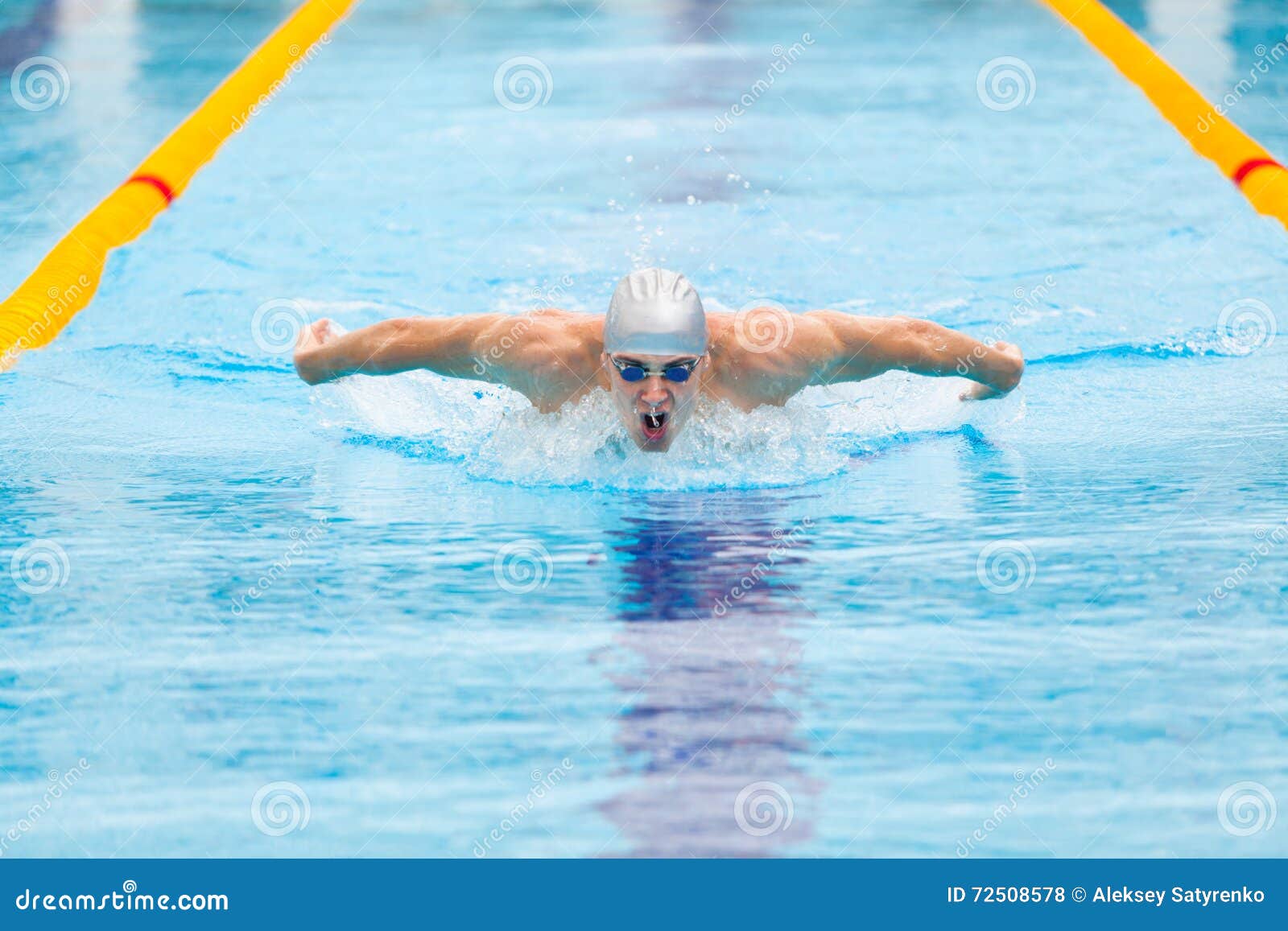Dynamic And Fit Swimmer Performing The Butterfly Stroke In Dark Ocean ...
