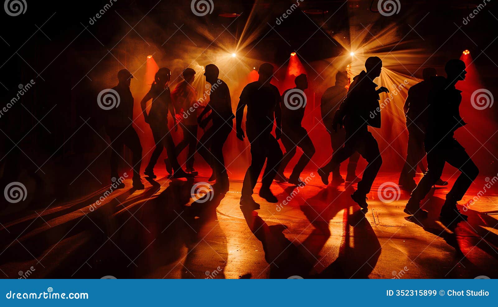 Dynamic Group of Dancers Performing Under Dramatic Stage Lights in a ...