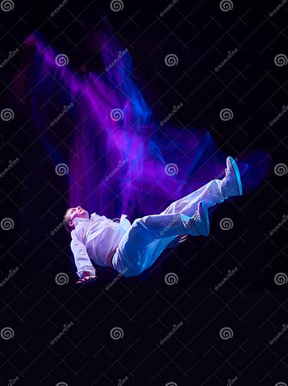 Dynamic Image of Young Man in Casual Clothes Falling Down Against Black ...