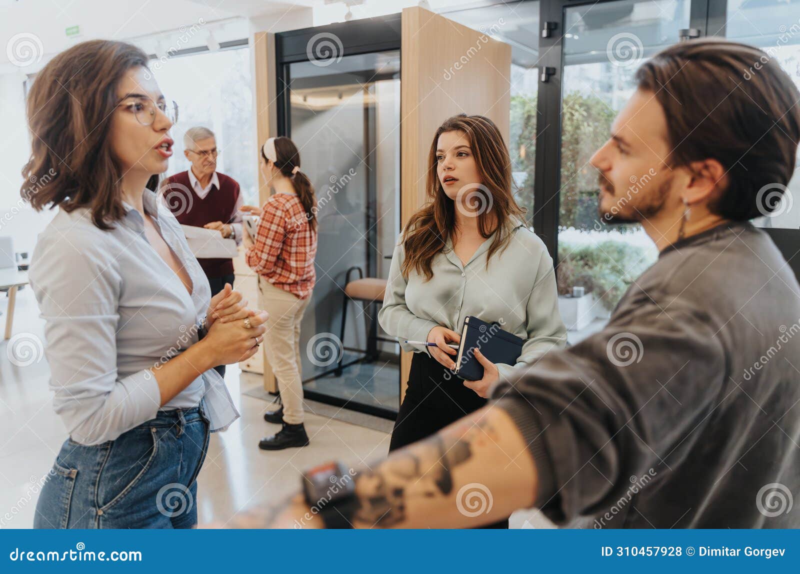 Group of Young Professionals Engaging in a Lively Conversation in a ...