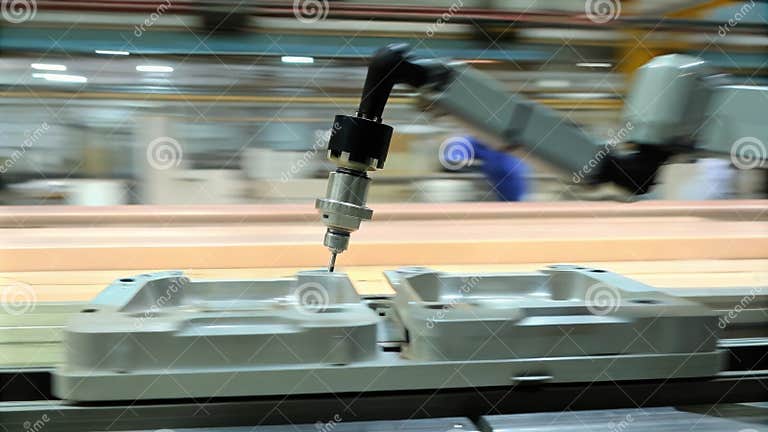 A Dynamic Shot of a Robotic Arm Precisely Aligning Two Halves of a Mold ...