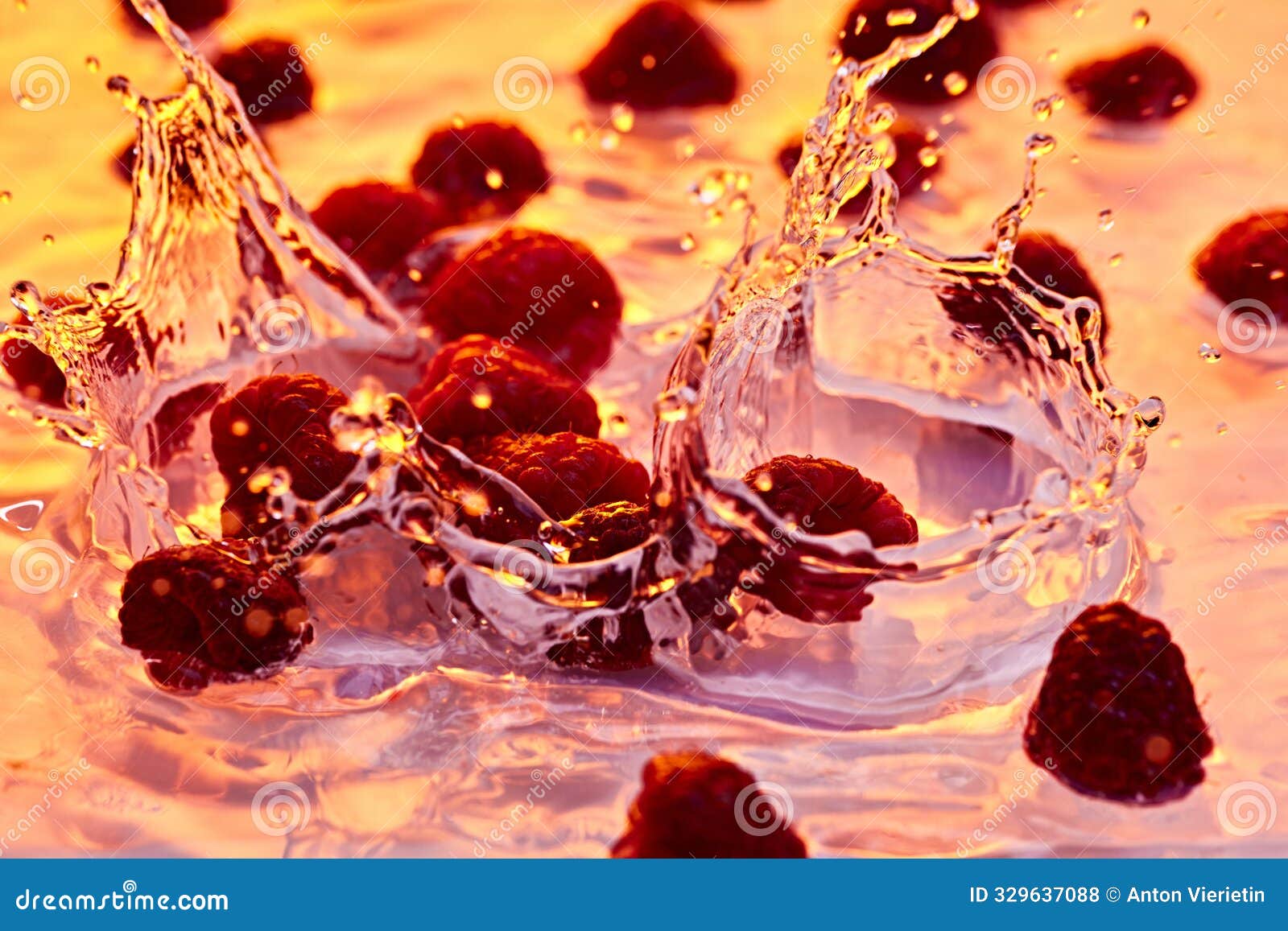 Dynamic Splash of Raspberry Hitting Water, with Scattered Berries in ...