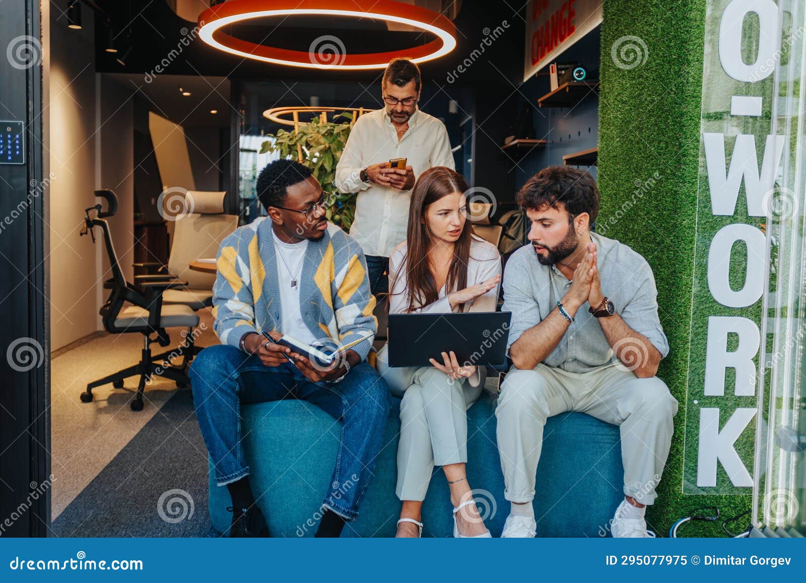 A Diverse Group of Professionals Collaborate in a Co-working Space ...