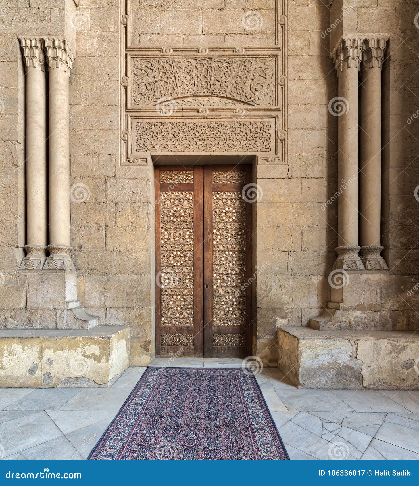 Bricks Stone Wall with Arabesque Decorated Wooden Door Framed by Stone ...