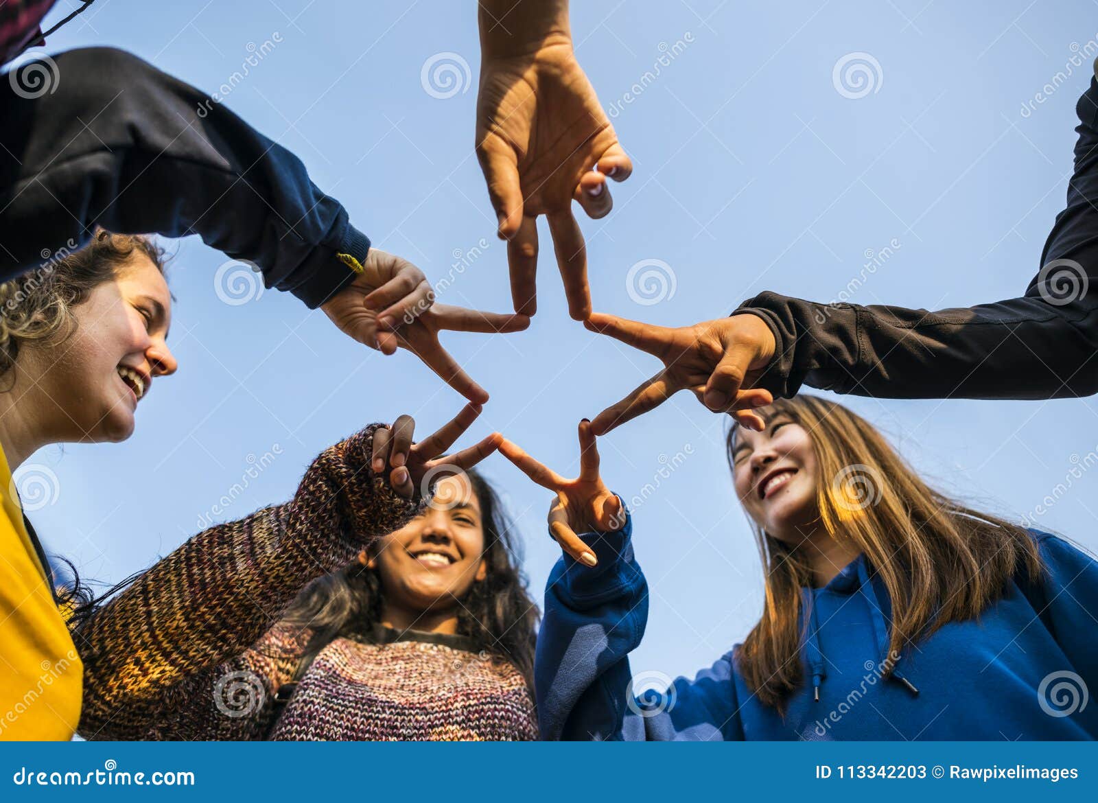 Group of Friends Using Fingers To Form the Star Shape Teamwork and ...