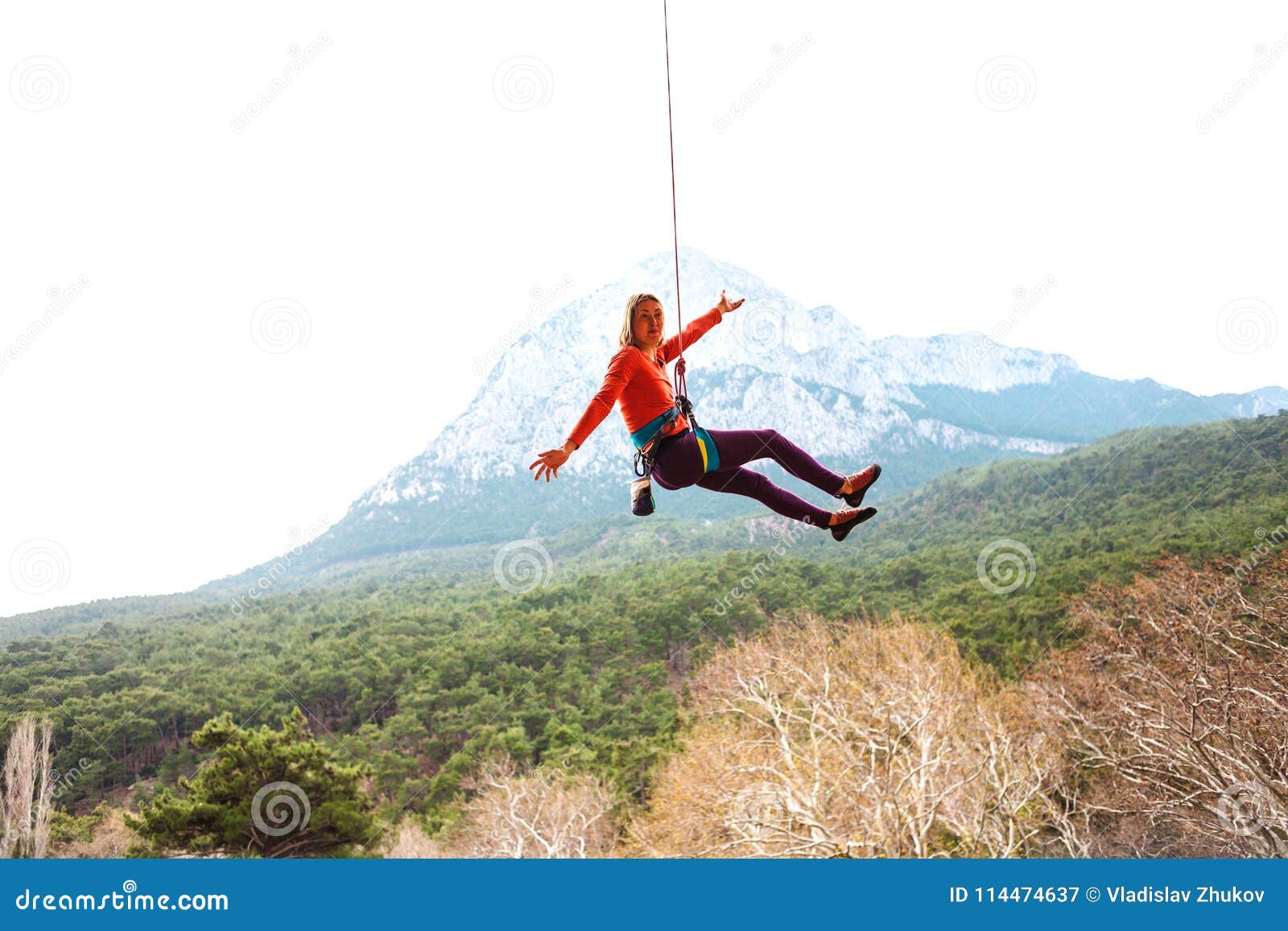 A Woman is Hanging on a Rope. Imagem de Stock - Imagem de escalar ...