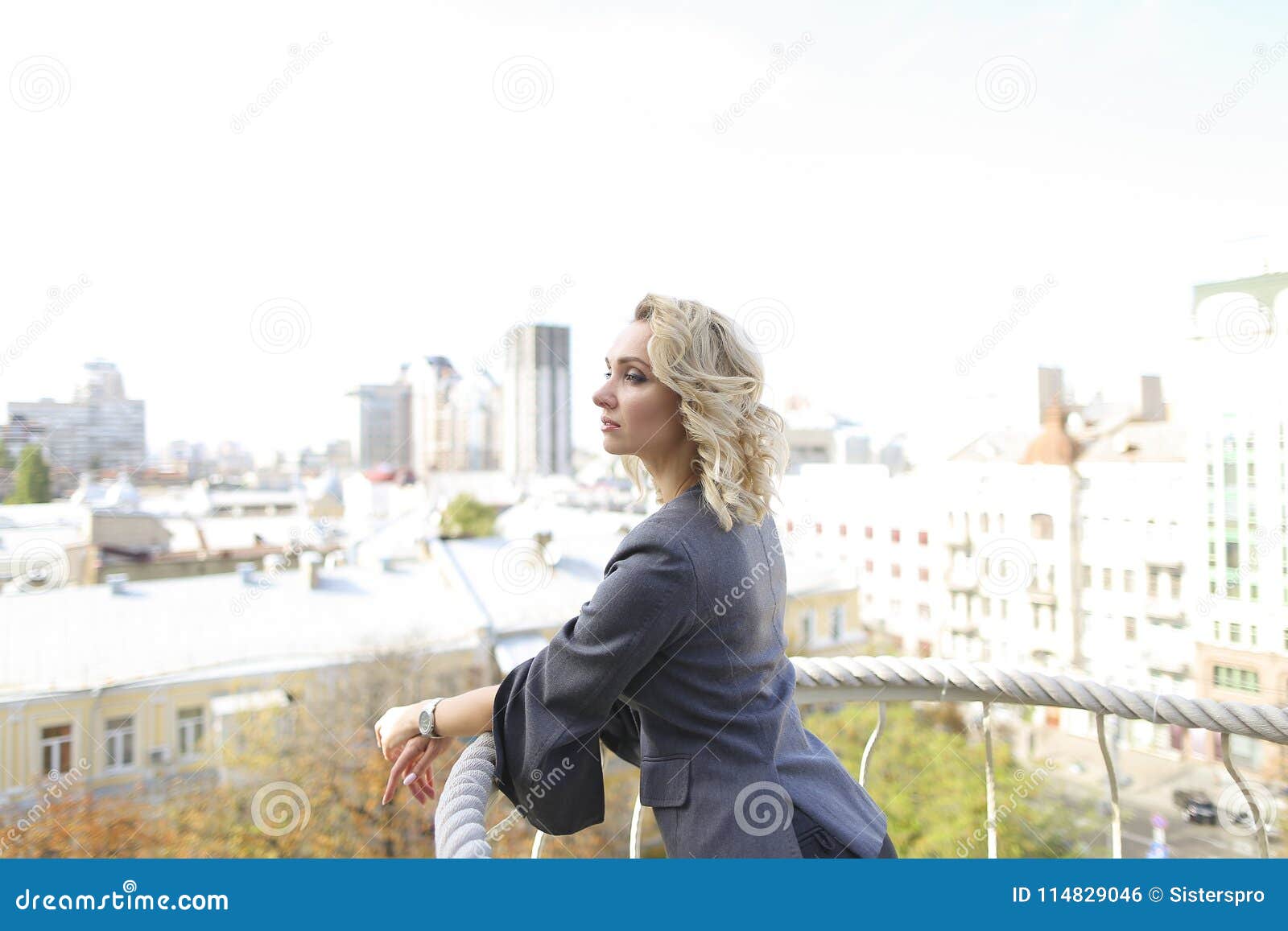 Young Female Person Standing on Balcony with Cityscape Background ...