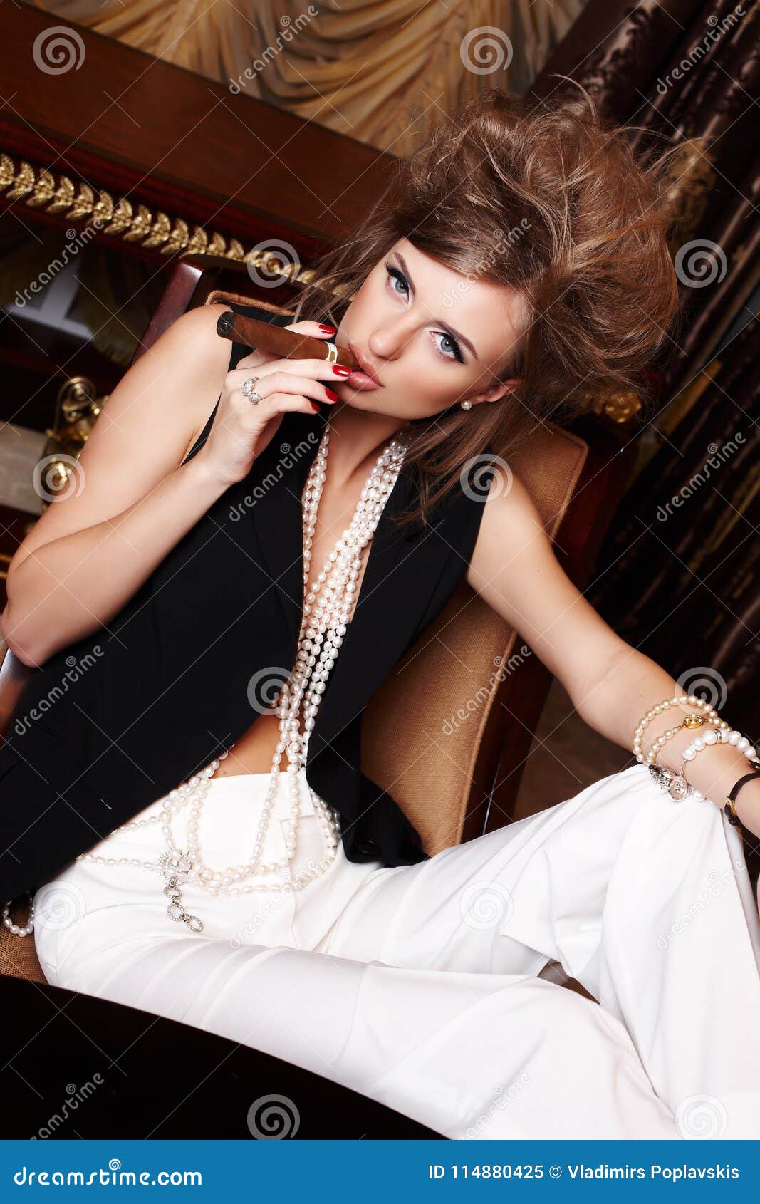 A Woman in a White Skirt Smoking a Cigar. Immagine Stock - Immagine di ...
