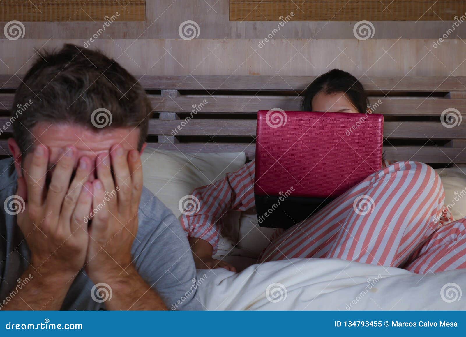 Angry And Frustrated Husband Moody In Bed Ignored By His Workaholic