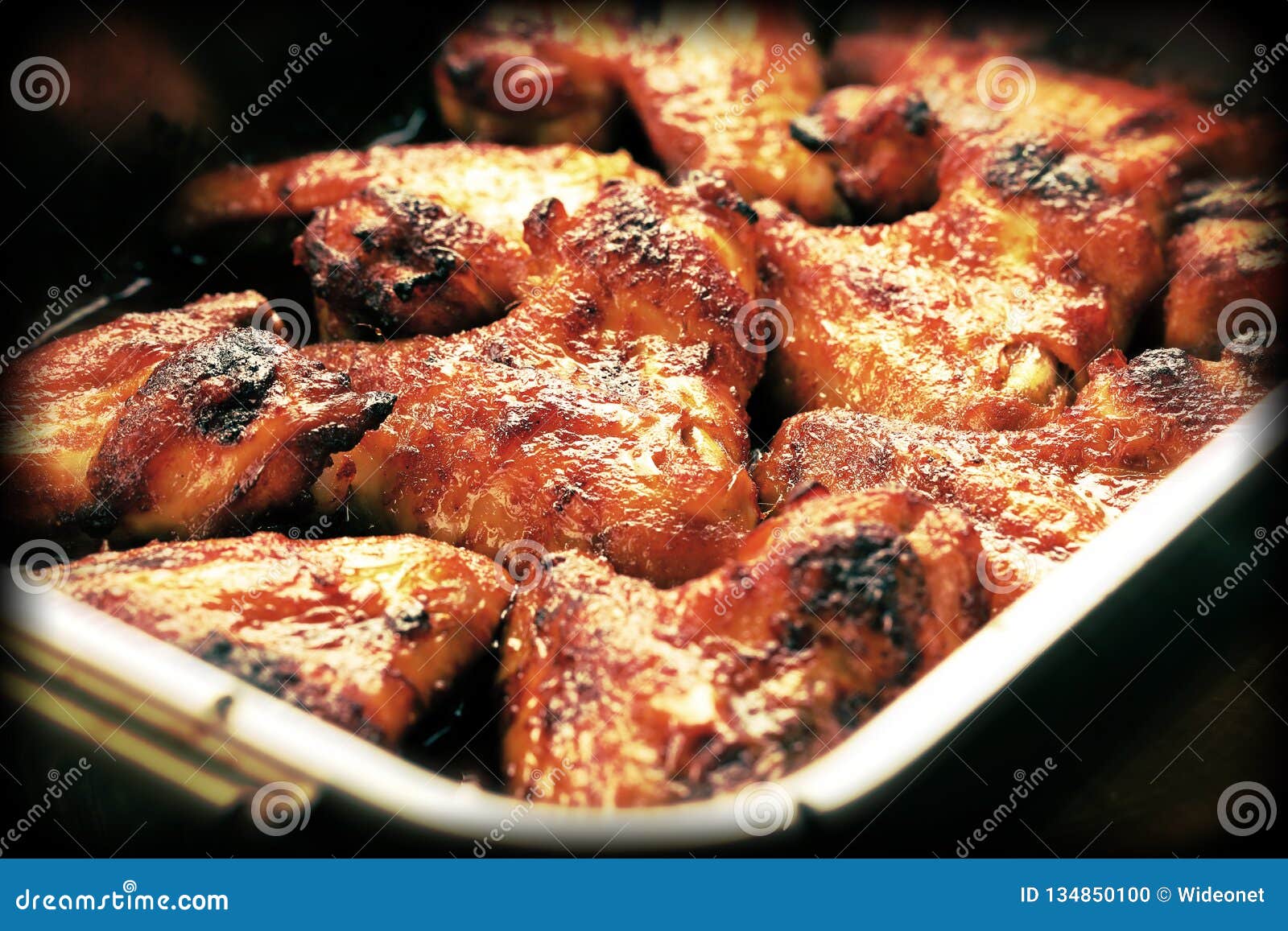 Roasted Chicken Wings with Baked Potato on the Table, Close Up Vintage ...