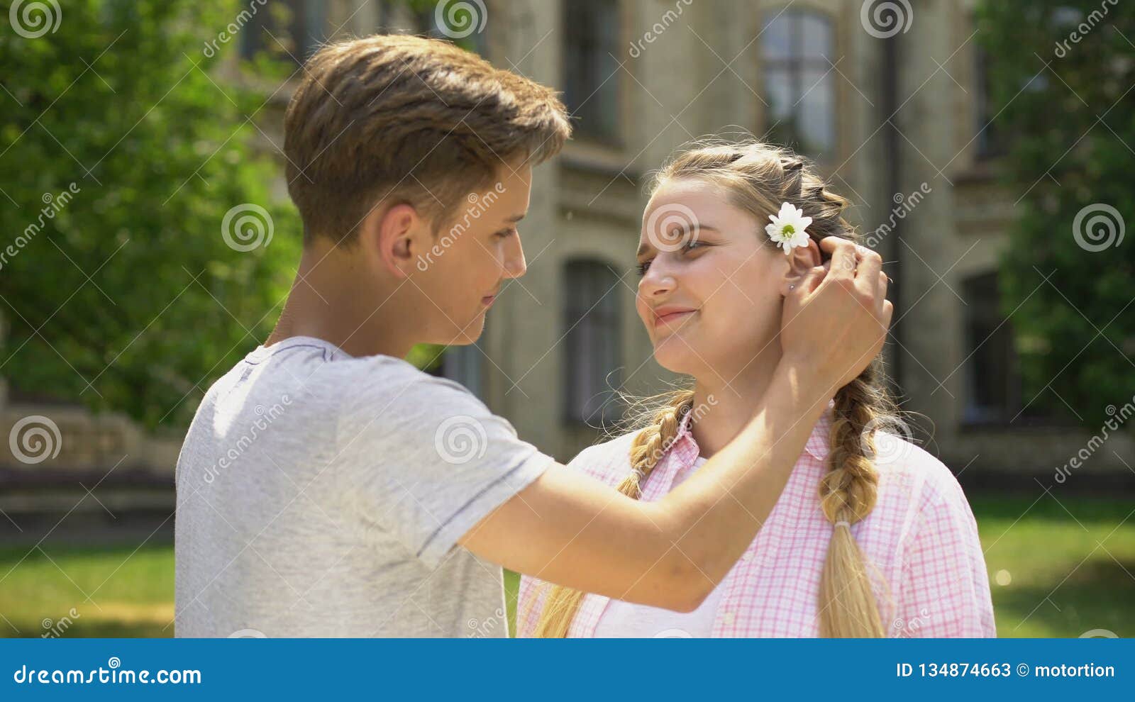 Teen Boy Putting Flower in Girlfriends Hair, First Love, Pure ...