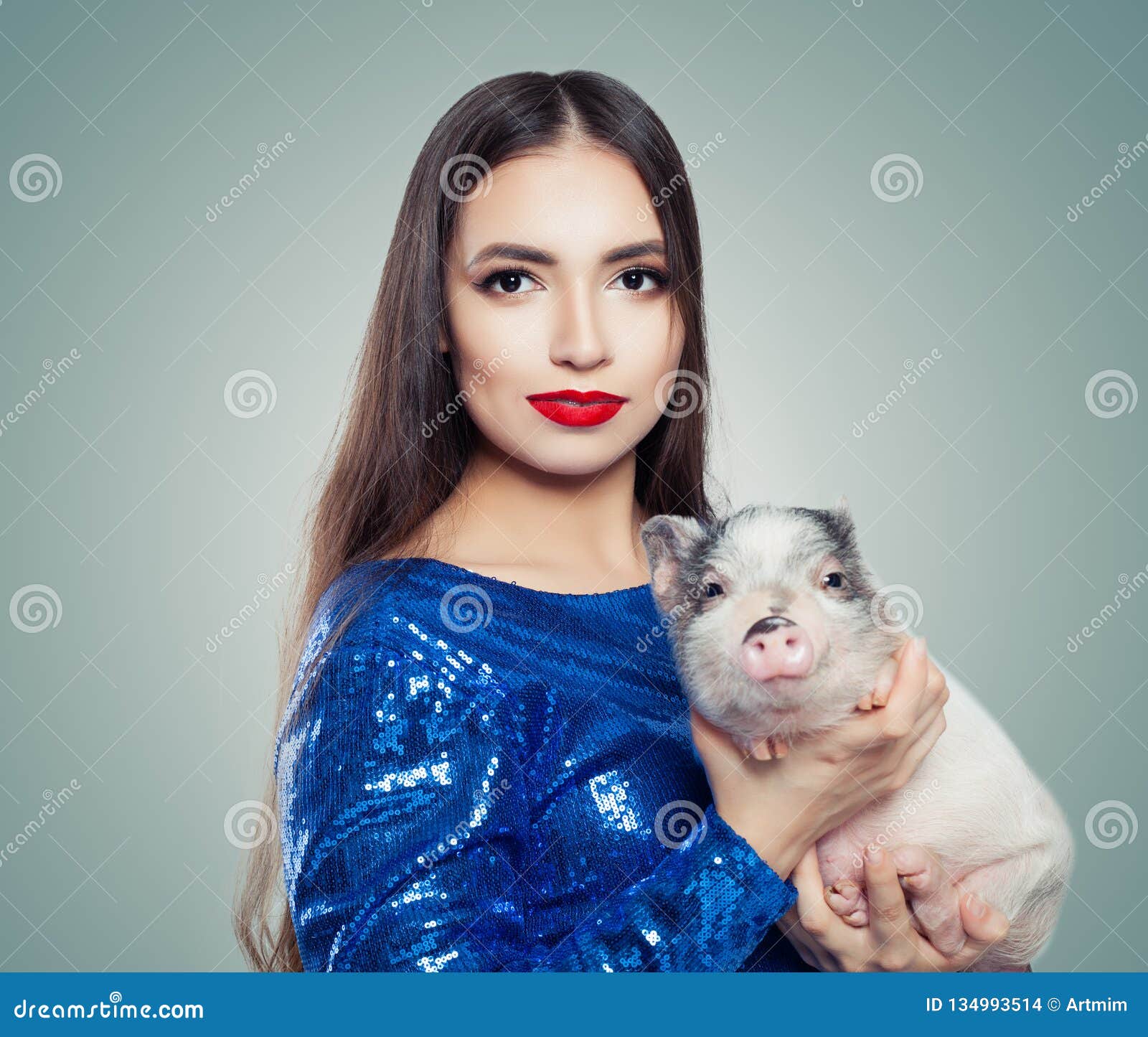 Beautiful Brunette Woman in Blue Glitter Dress Holding Little Pig Στοκ ...