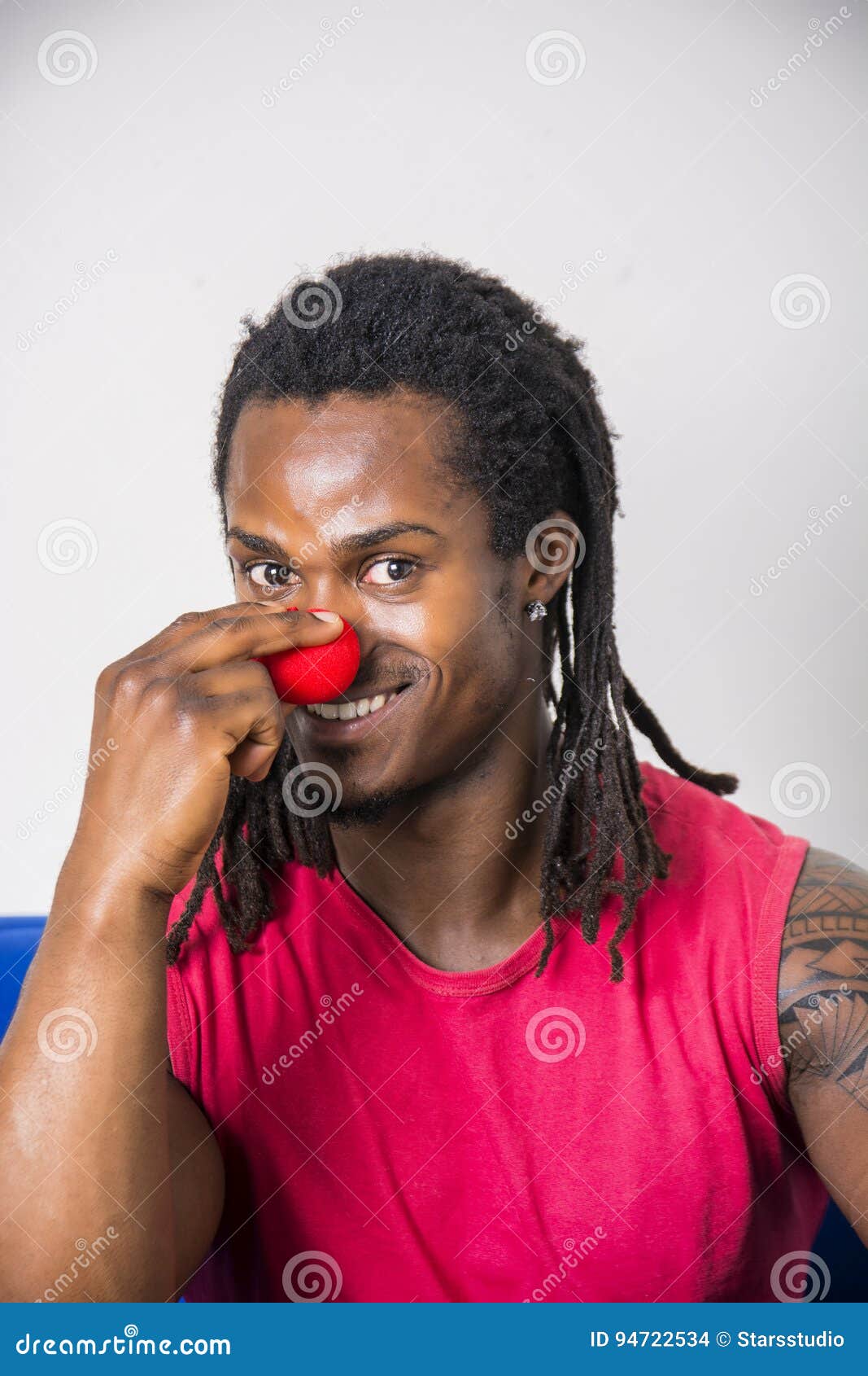 Handsome Young Man Smiling and Touching Red Clown Nose, Stockfoto ...