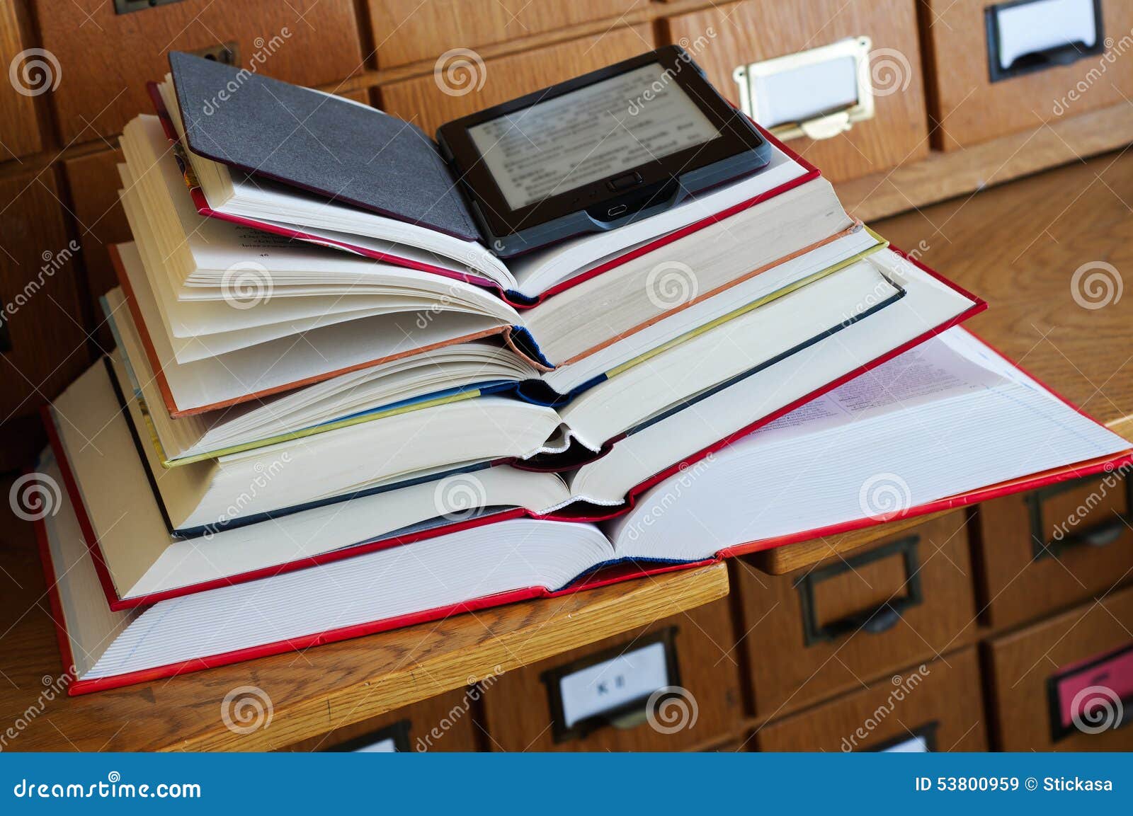 E-book Reader on Top of Stack of Books in a Library Stock Image - Image ...