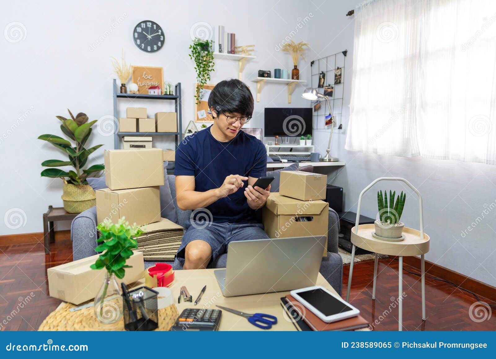 E-commerce Concept a Male Online Merchant Using the Electronic Devices ...