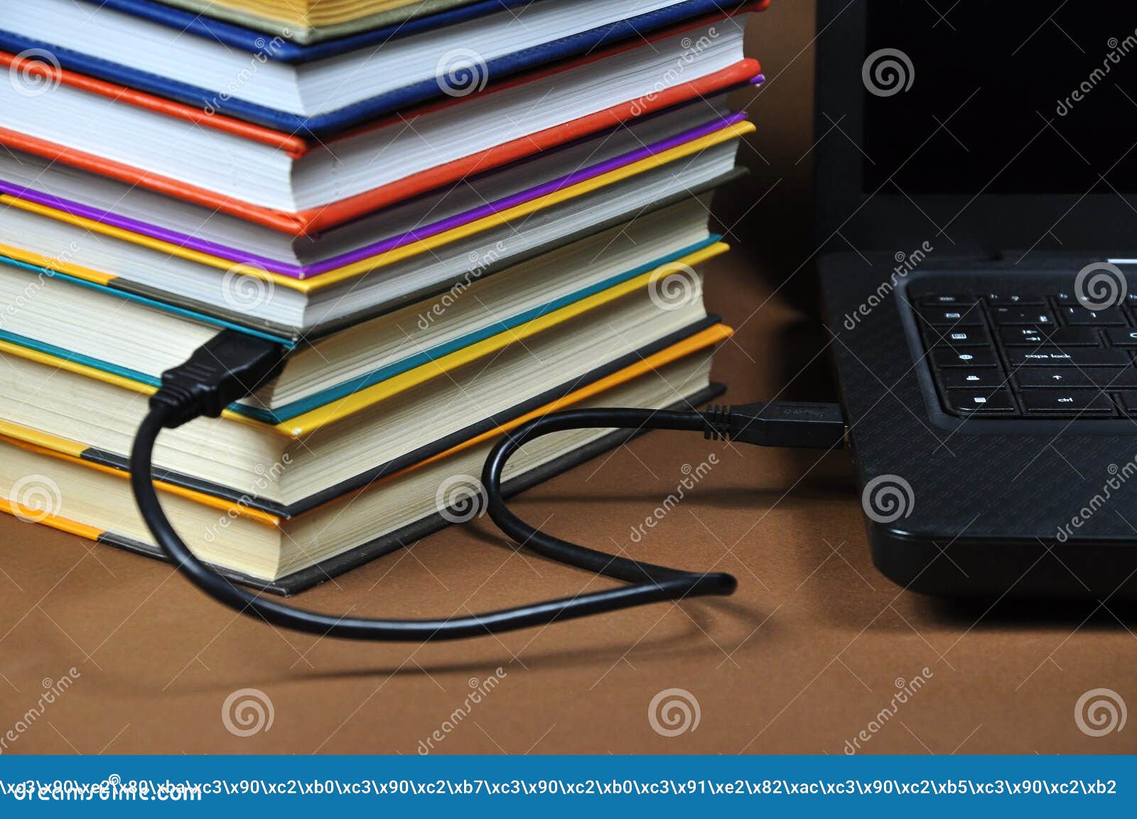 A Laptop and a Stack of Books Connected by a Cable Stock Image - Image ...