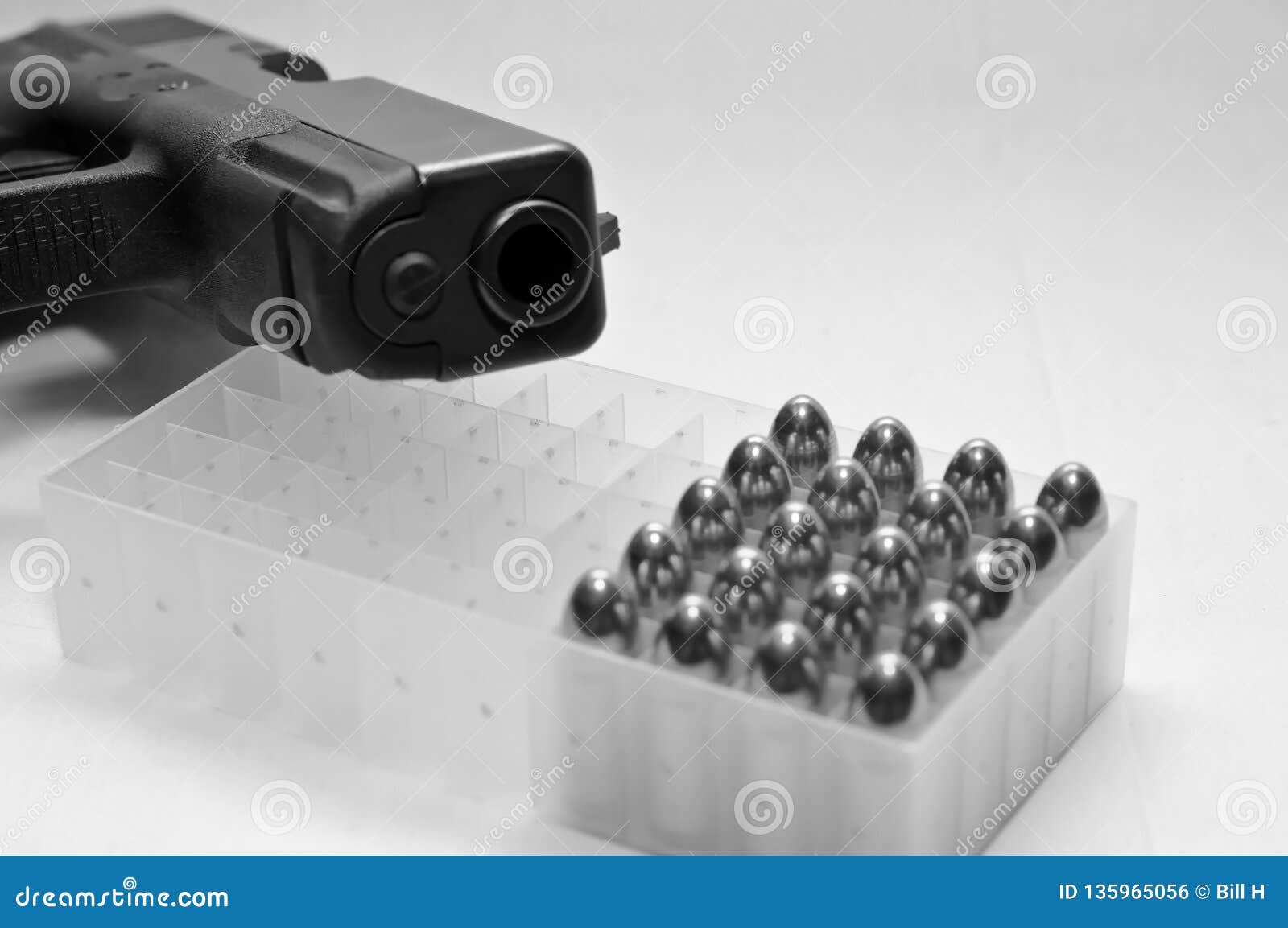 A Black Semiautomatic 9mm Pistol Laying on Top of a Plastic Bullet Case ...