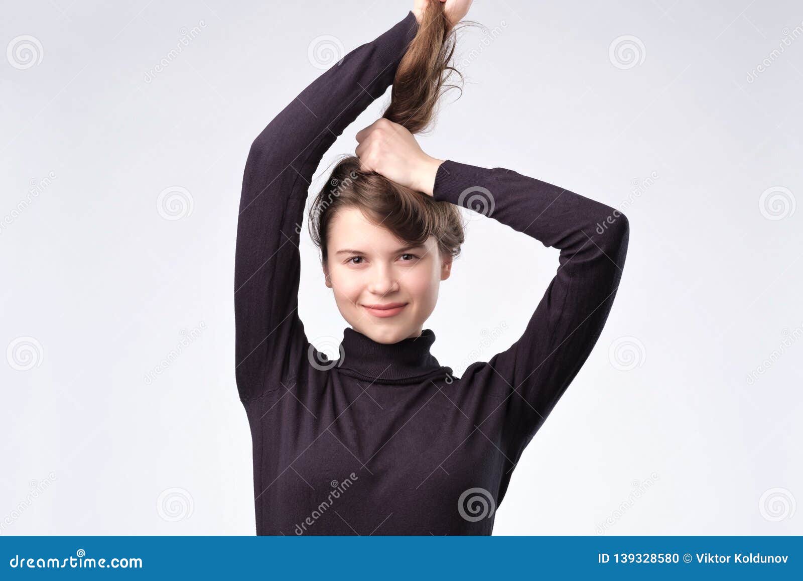 Young Beautiful Girl Pulls Her Long Hair Up with Hands Photo stock ...