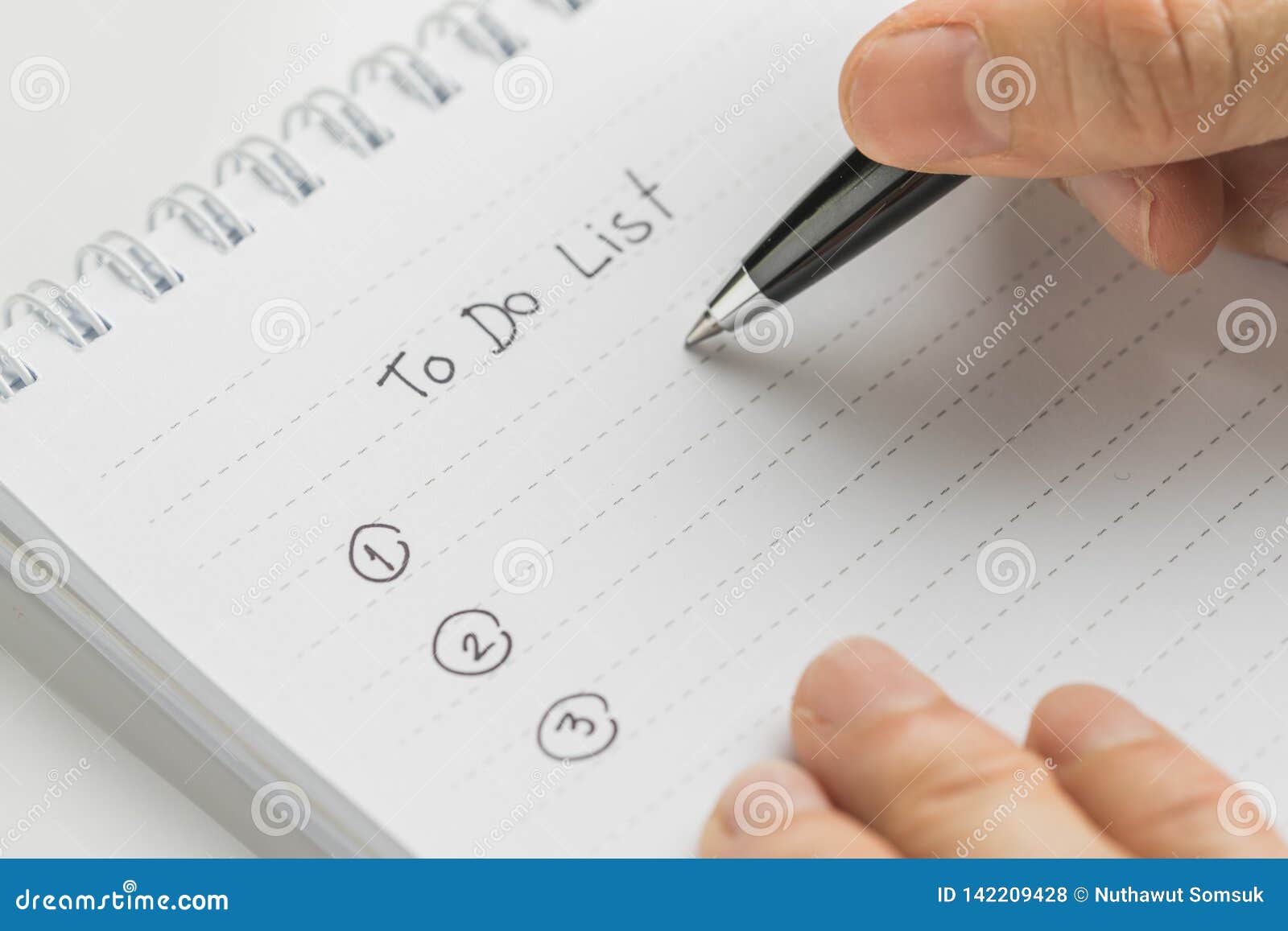 Hand Holding Pen Writing What To Do in Personal To Do List Note Pad on ...