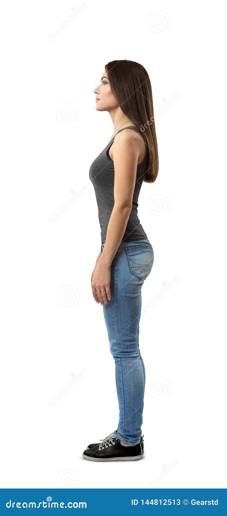 Side View of Young Attractive Woman in Gray Sleeveless Top and Blue ...