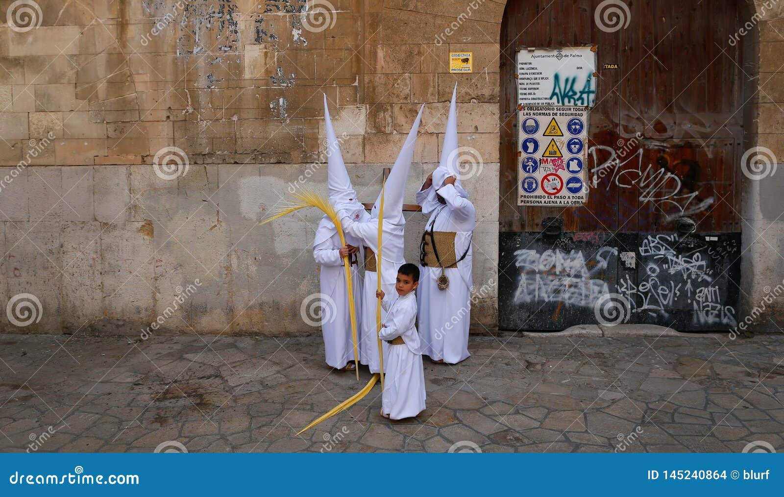 A Family of Penitents Preparing before the Start of an Easter Holy Week ...
