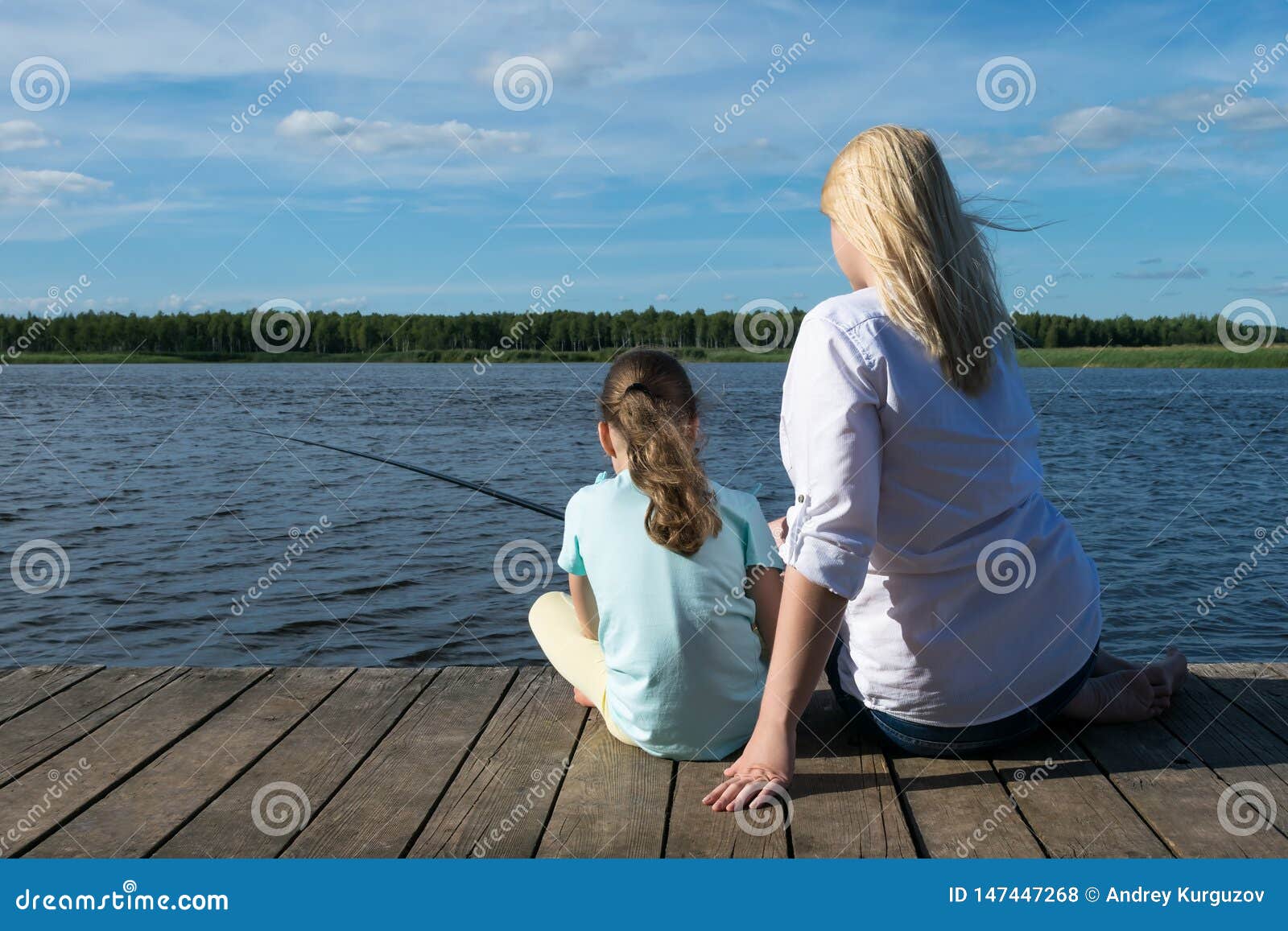 Woman with Her Daughter is Fishing on the Pier in Sunny Weather, Rear ...