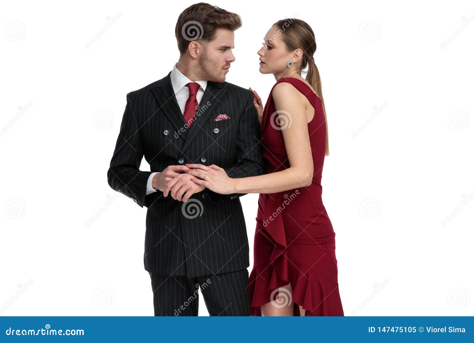Passionate Couple Looking while she is Romantically Touching His Arm ...
