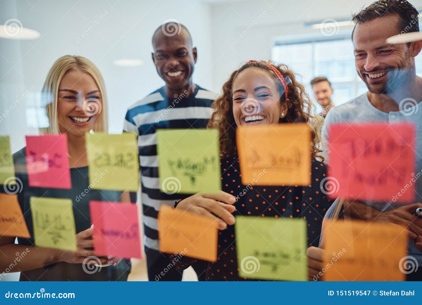 Laughing Work Colleagues Brainstorming Together in an Office Stock ...