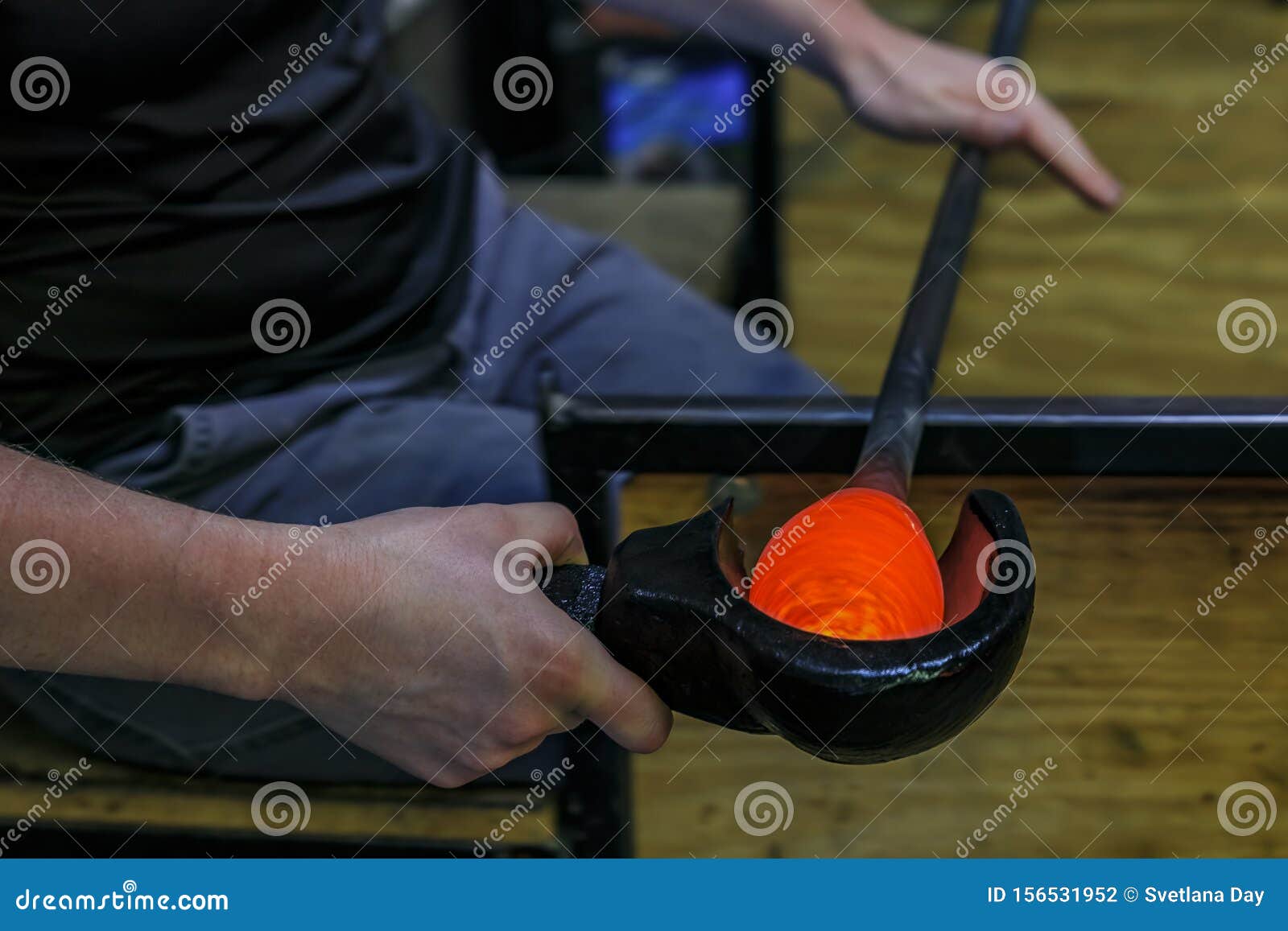 Glass Blower Shaping a Bubble of Melted Glass on a Rod by Hand at a ...