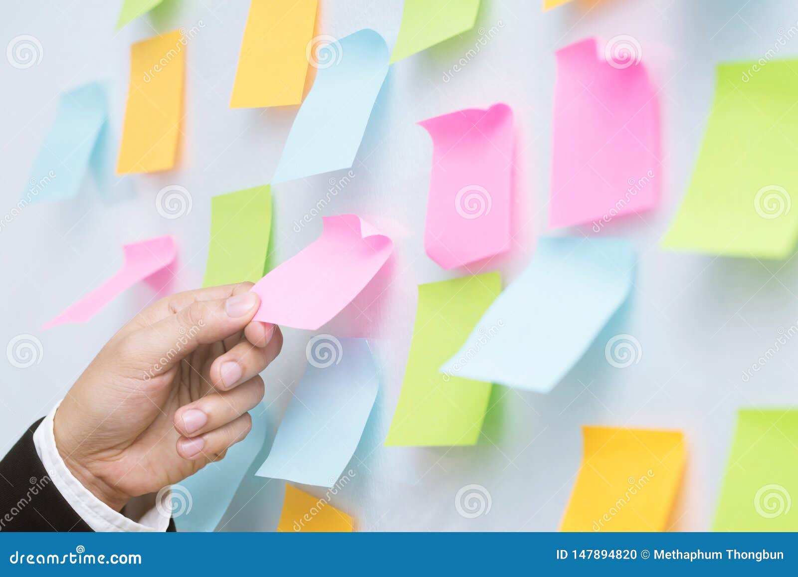 Close Up Hand People Business Man Post it Notes in the Wall at Meeting ...
