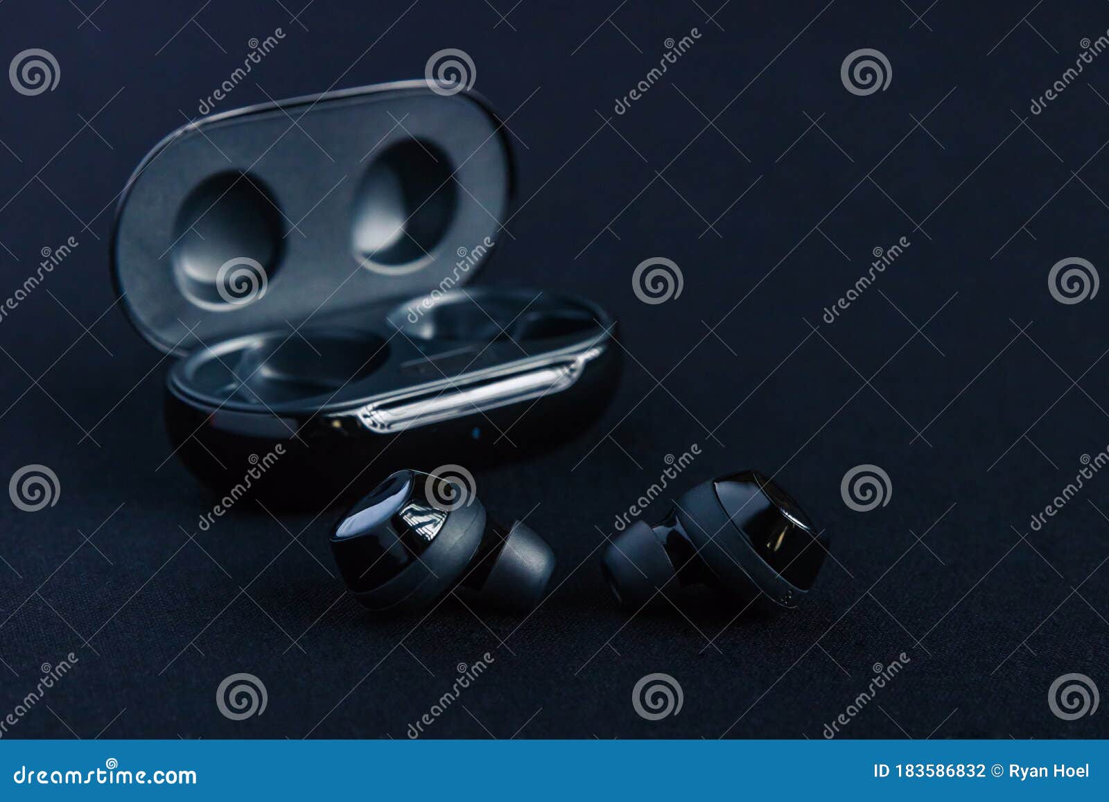 Earbud Headphones Side Profile - Displayed in Front of Opened Black ...