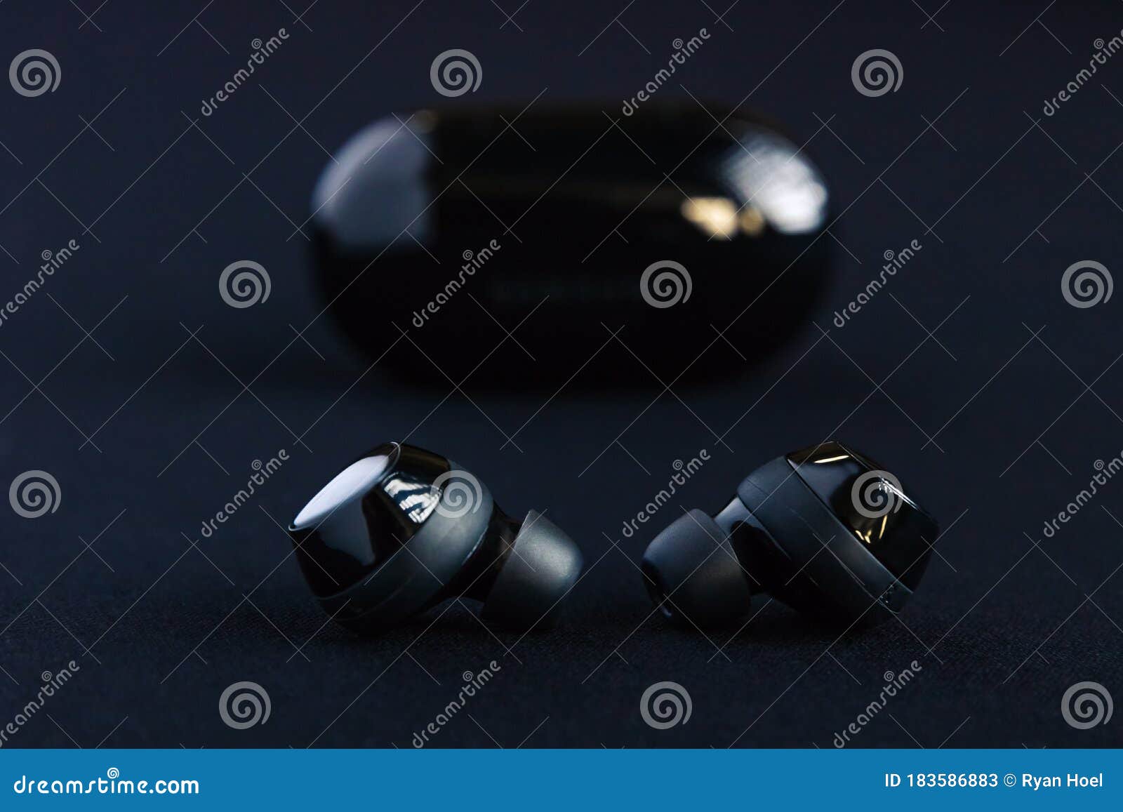 Earbud Headphones Side Profile - Displayed in Front of Opened Black ...