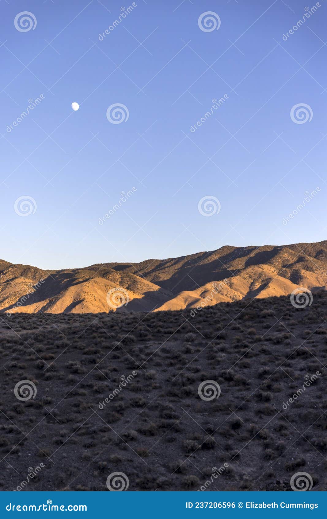 An Early Moon Shines High Over the Mountains during the Sunset Evening ...
