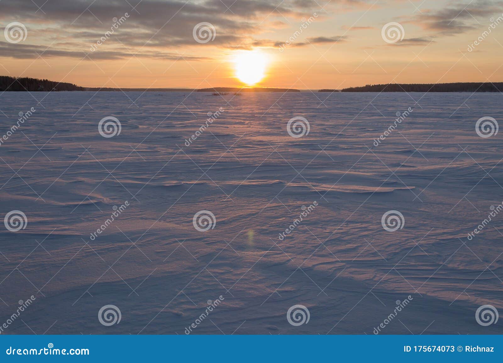 Early Morning On The Frozen Snow Covered Lake Ripples In The Snow