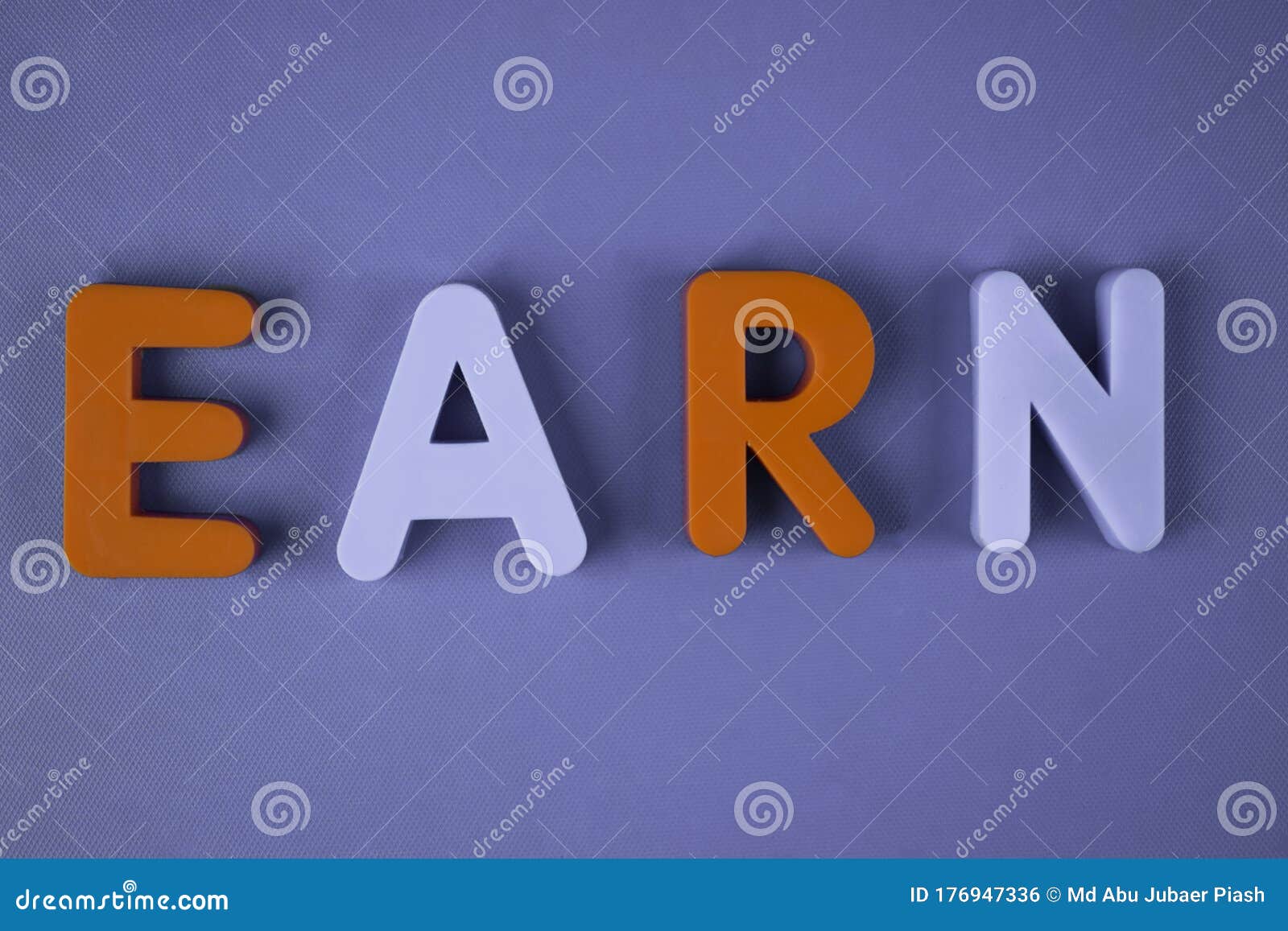 Earn Word Written with Different Colored Letter Blocks on a Blue ...