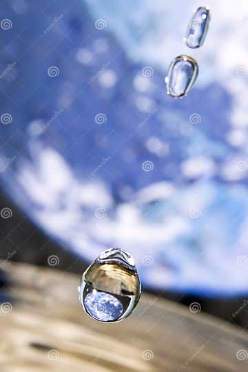 Earth in drop of water. stock photo. Image of colored - 11893926
