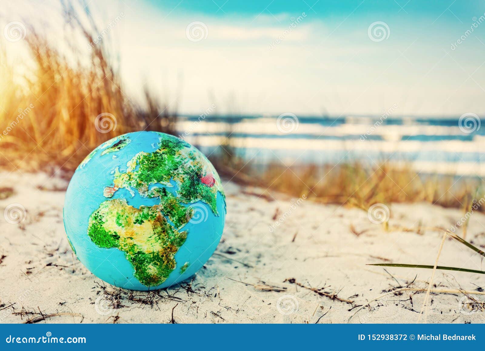 Earth globe on the beach stock photo. Image of ocean - 152938372