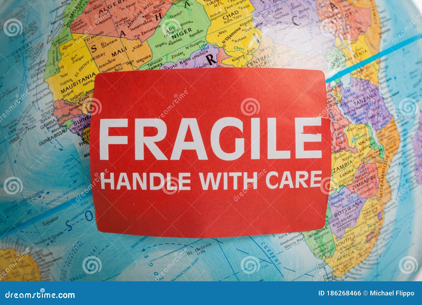 An Earth Globe with a Fragile Hand with Care Sticker Stock Photo ...