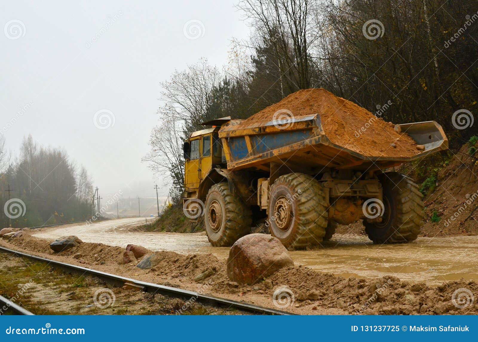 Earth Mover Loading Dumper Truck with Sand in Quarry. Excavator Loading ... Earth Mover Loading Dumper Truck with Sand in Quarry. Excavator Loading ...