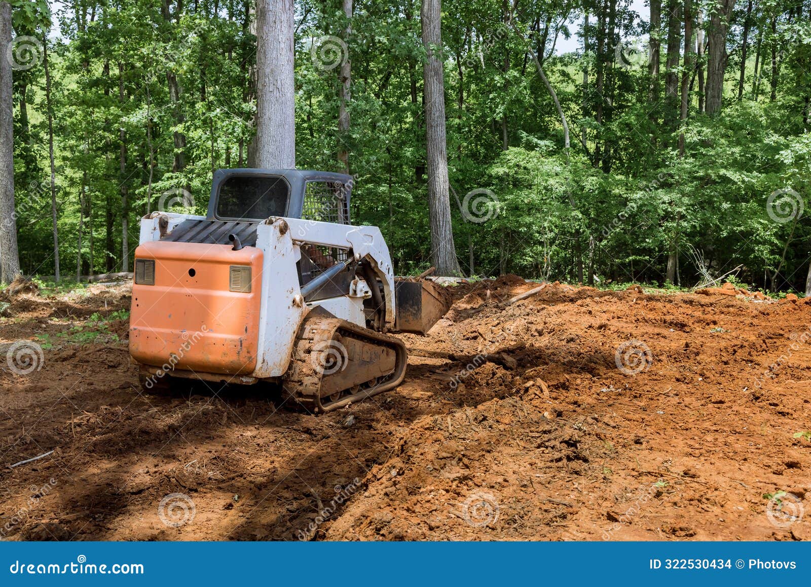 An Earthmoving Tractor is Leveling Ground during a Construction Project ...