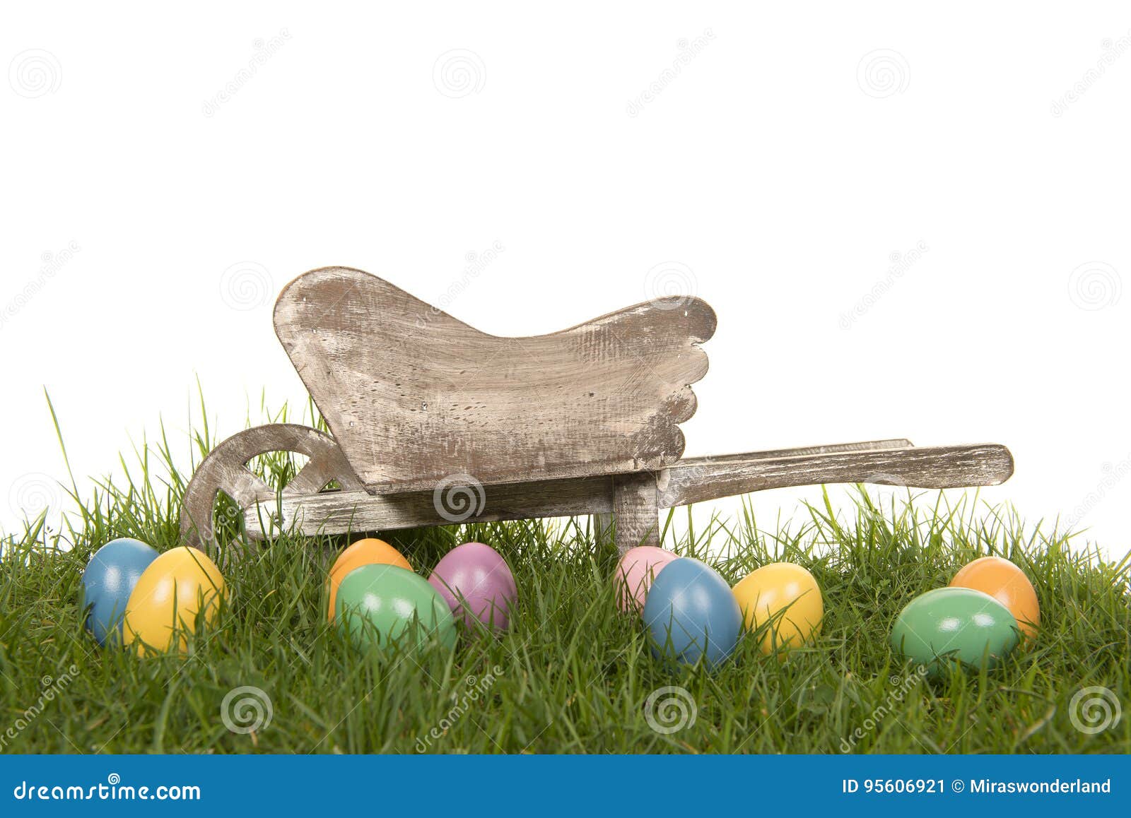 Easter Background with Colored Eggs in the Grass and a Wooden ...