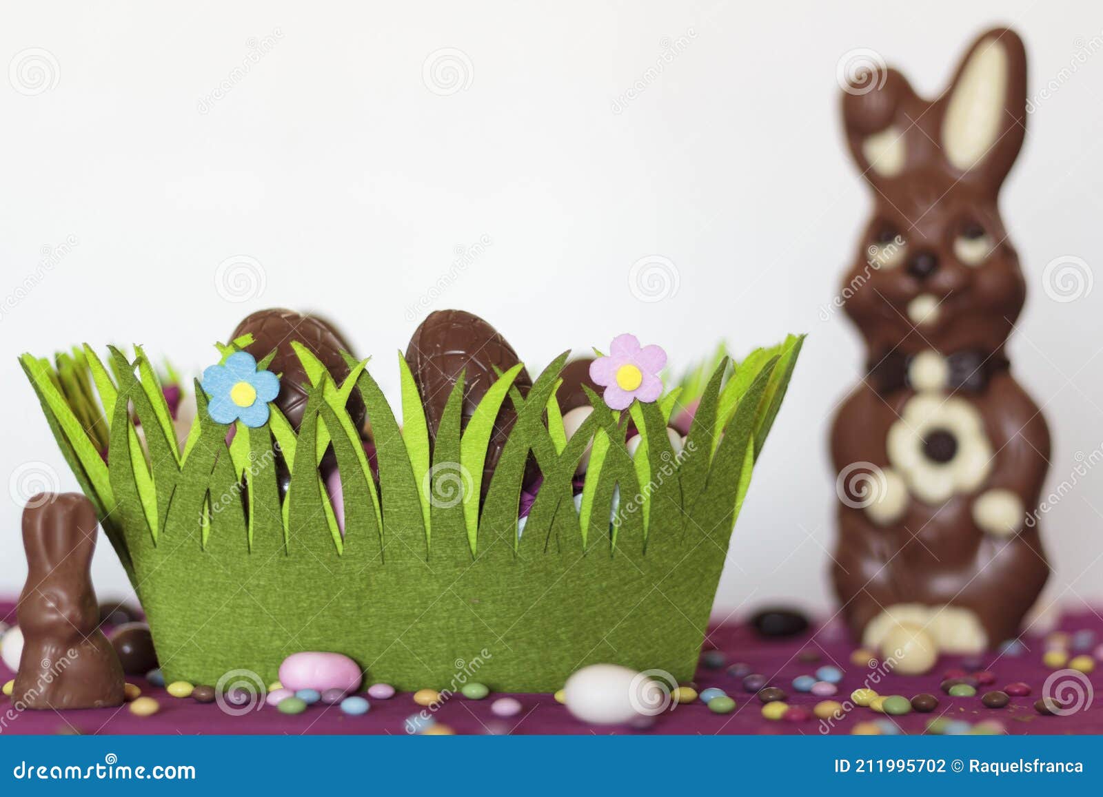 Easter Basket with Chocolate Eggs, Chocolate Bunny and Sweets on Table ...