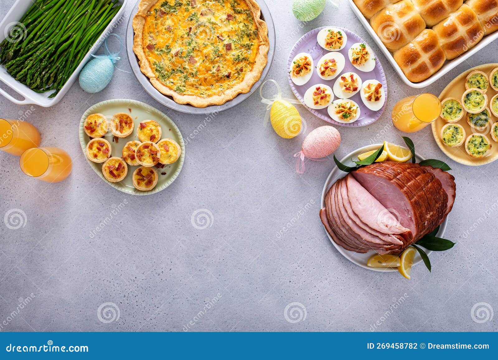 Easter Brunch Table with Ham, Quiche, Hot Cross Buns Stock Photo ...