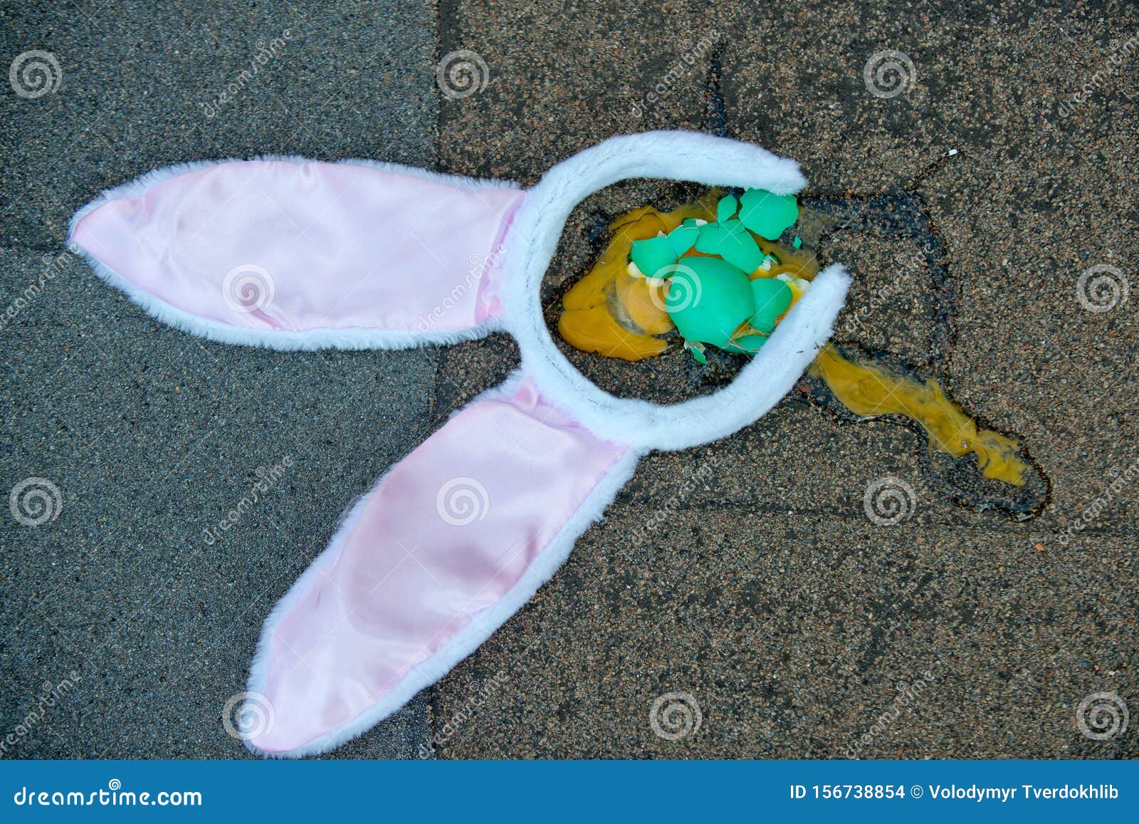 Easter Bunny Ears Headband and Egg Broken on Asphalt Background Stock ...