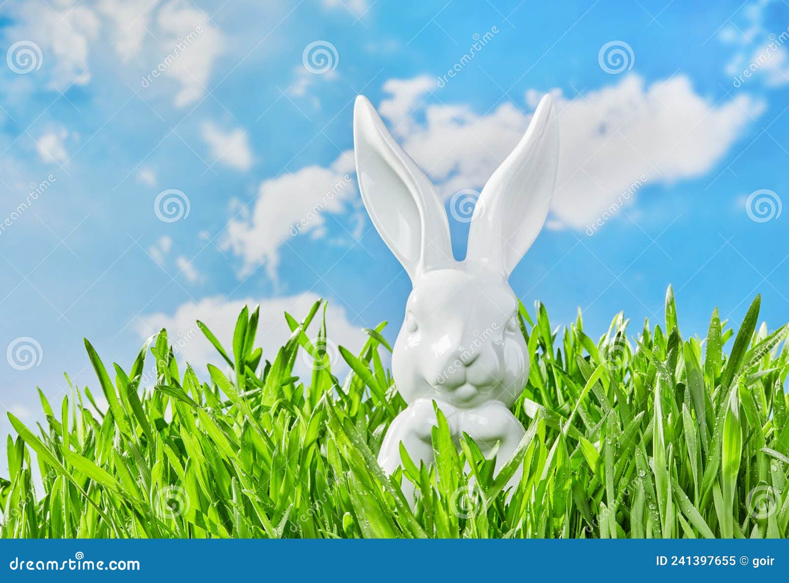 Easter bunny in the grass stock image. Image of blue - 241397655
